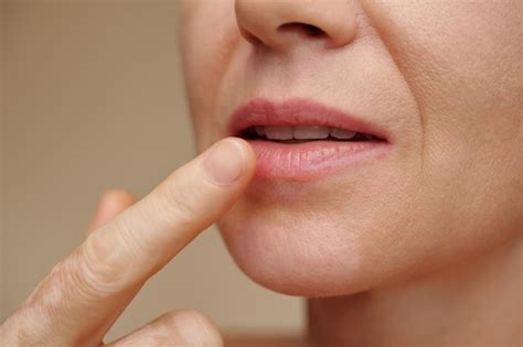 Premium Photo | Woman applying hydrating lip teatment