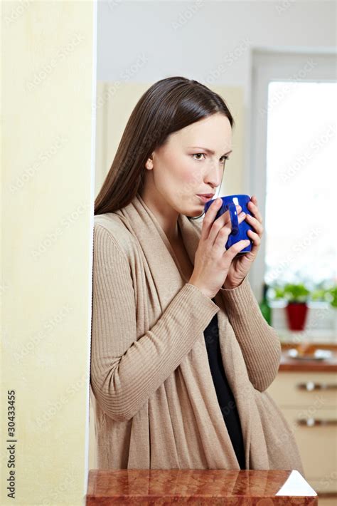 Frau pustet in Kaffeetasse Stock Photo | Adobe Stock