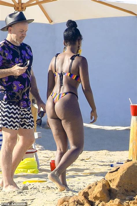 Janelle Monae showcases her flawless figure in a skimpy striped bikini ...