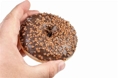 Chocolate donut on white wooden background close-up - Creative Commons ...