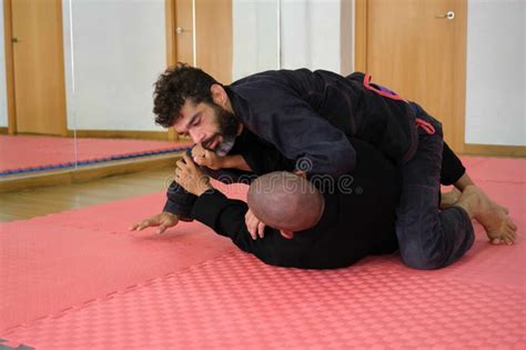 Two Men Practicing Brazilian Jiu-Jitsu Sparring at the Academy. Stock Photo - Image of kimono ...