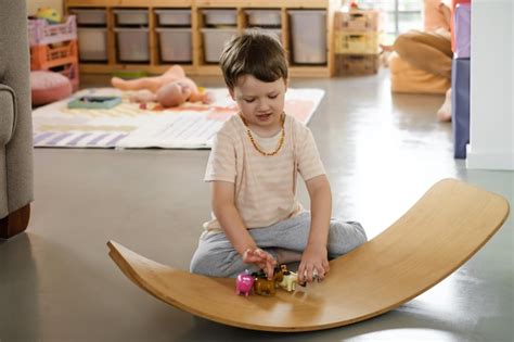 Premium Photo | Children playing on balance board for toddlers in kids room