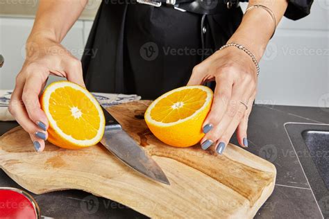 Hand squeezing fresh orange juice on white background for recipes and healthy drinks. 41442403 ...