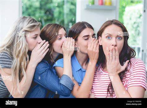 Women in a row whispering secrets in their friends ears Stock Photo - Alamy