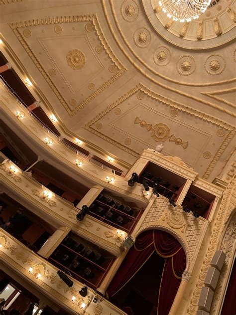an auditorium with chandeliers and lights on the ceiling