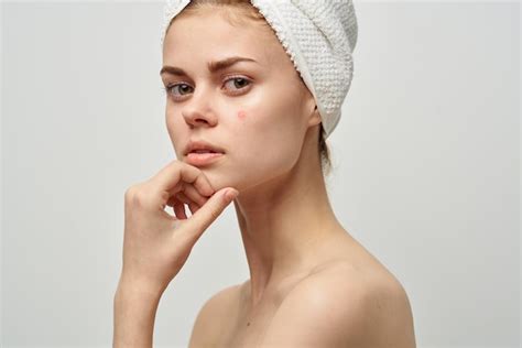 Premium Photo | Beautiful woman with a pimple on the face cosmetology studio high quality photo